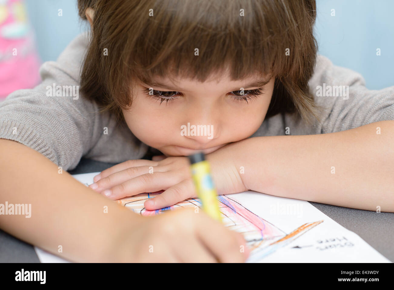 Lonely Girl drawing at kindergarten Stock Photo - Alamy