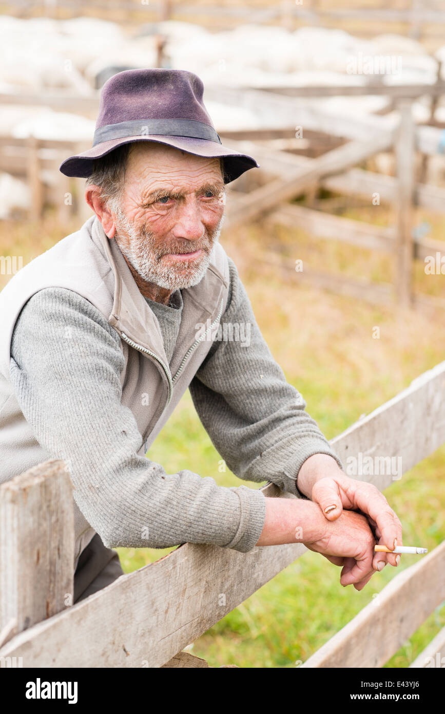 Old shepherd man smoking reflexive Stock Photo - Alamy