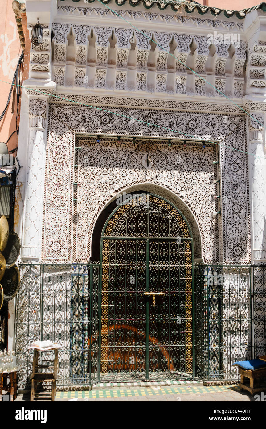 Ornate ceramic tiles and ironwork around an arched doorway in Marrakech ...
