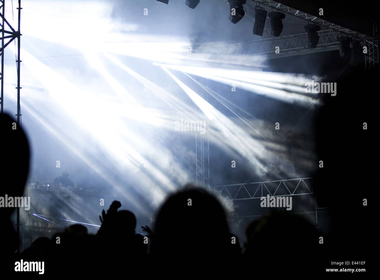 Cheering crowd in front of bright colorful stage lights Stock Photo - Alamy