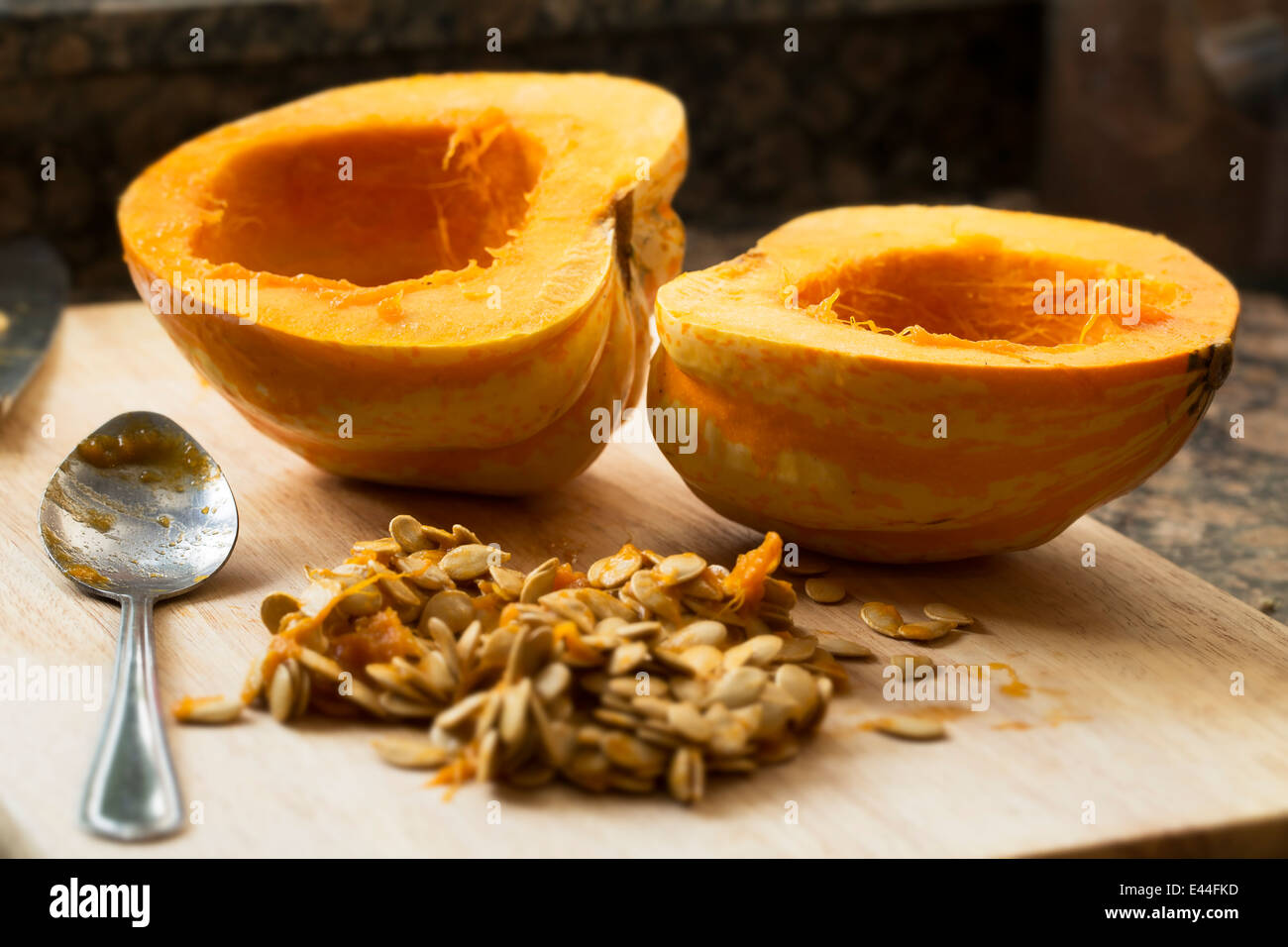 Winter squash cut in half with spoon and seeds scooped out Stock Photo ...