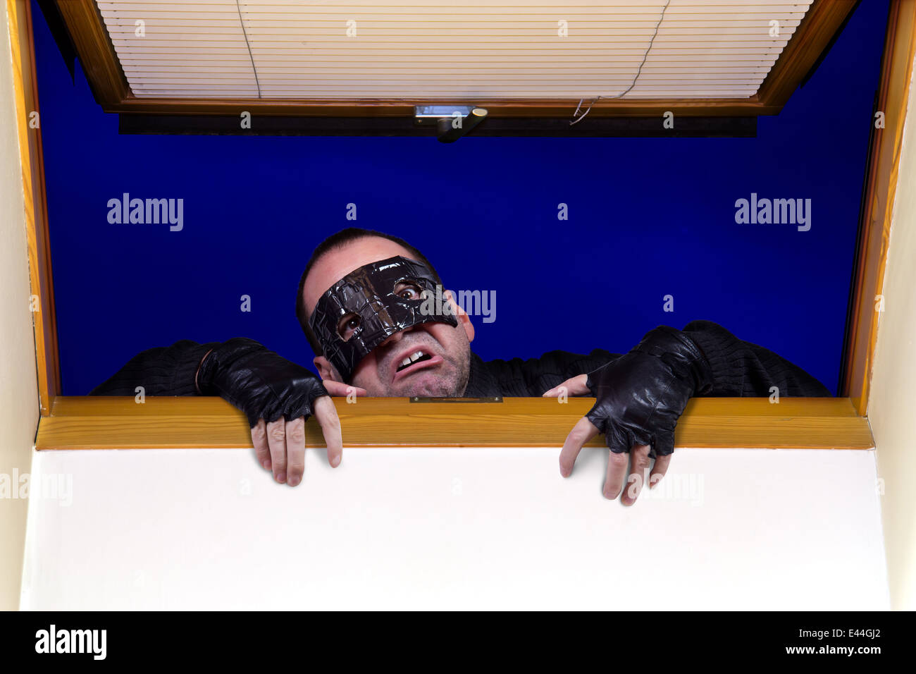 A robber enters the house through the roof window Stock Photo - Alamy