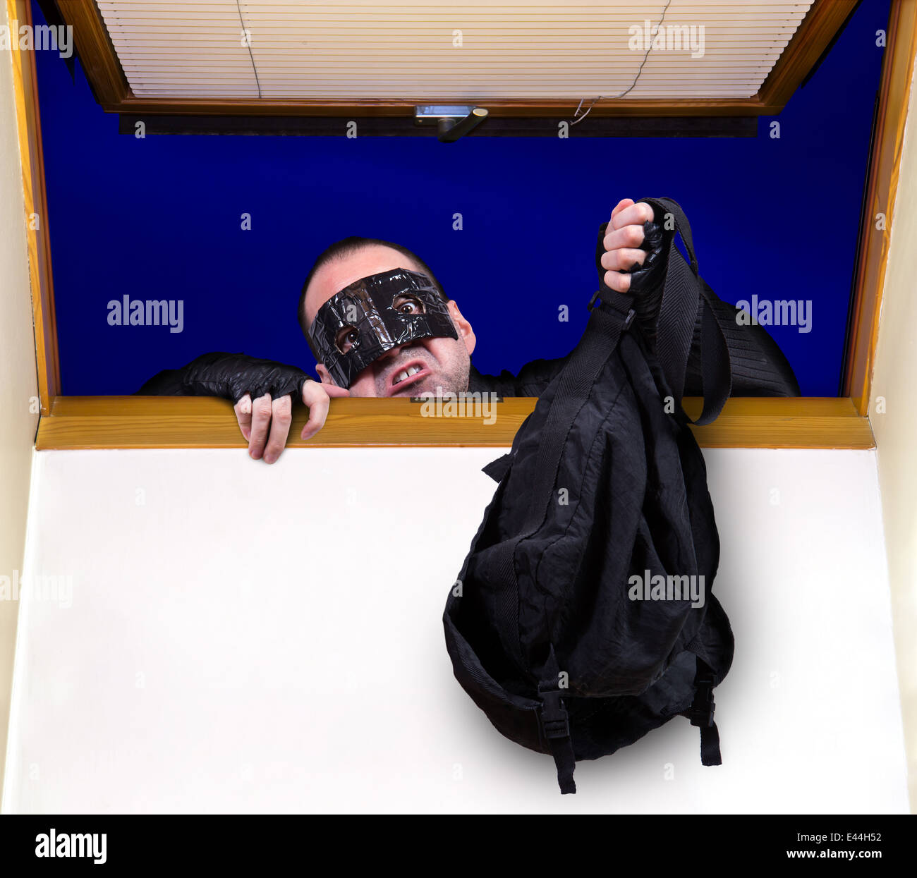 A robber enters the house through the roof window Stock Photo - Alamy