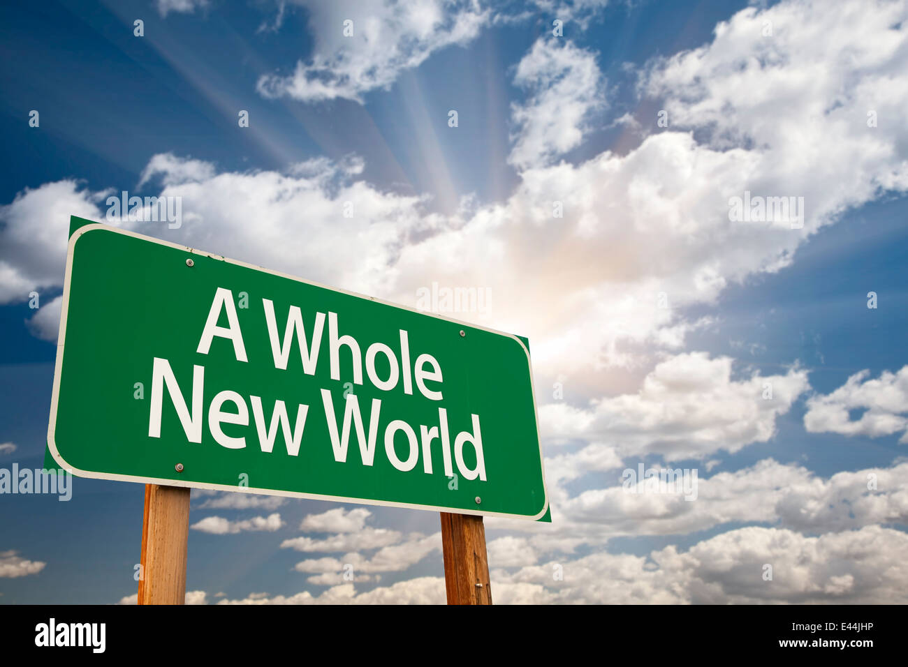 A Whole New World Green Road Sign with Dramatic Clouds and Sky Stock ...