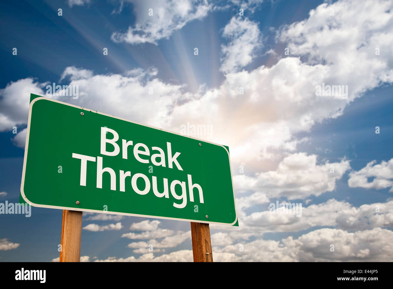 Break Through Green Road Sign with Dramatic Clouds and Sky Stock Photo ...