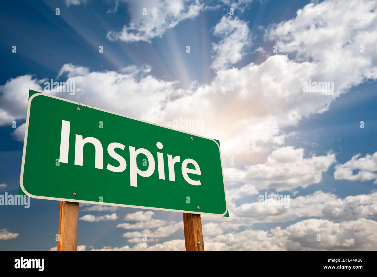 Inspire Green Road Sign with Dramatic Clouds and Sky Stock Photo - Alamy