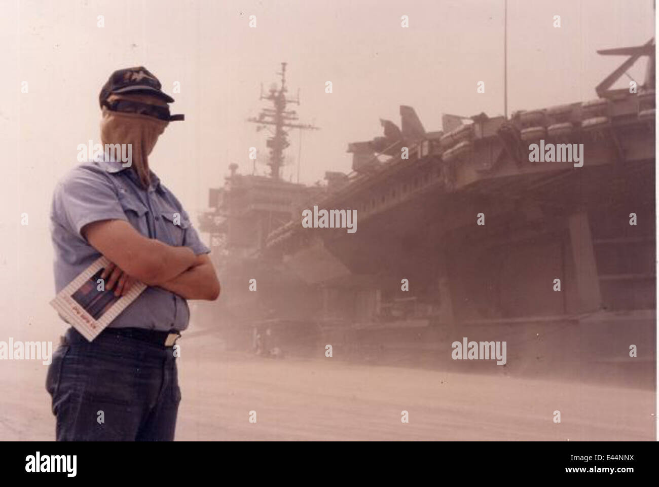 A photograph of a masked U.S. Navy sailor from Carrier Air Wing 15 (CVW ...