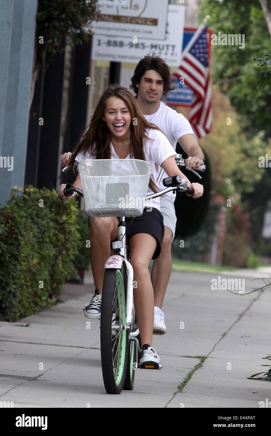 Miley Cyrus and her boyfriend Justin Gaston take a morning bike ride to ...