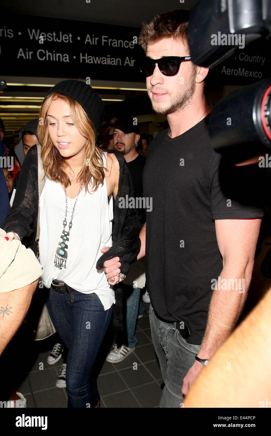 Miley Cyrus and Liam Hemsworth Miley Cyrus arrives at LAX airport on a ...
