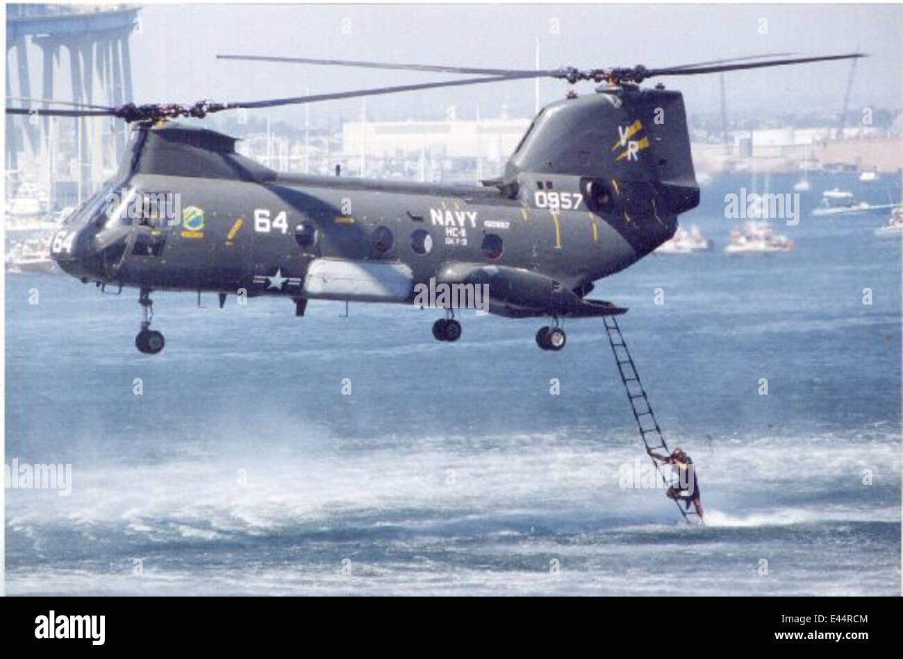 A photograph showing a CH-46A helicopter performing a water pickup ...