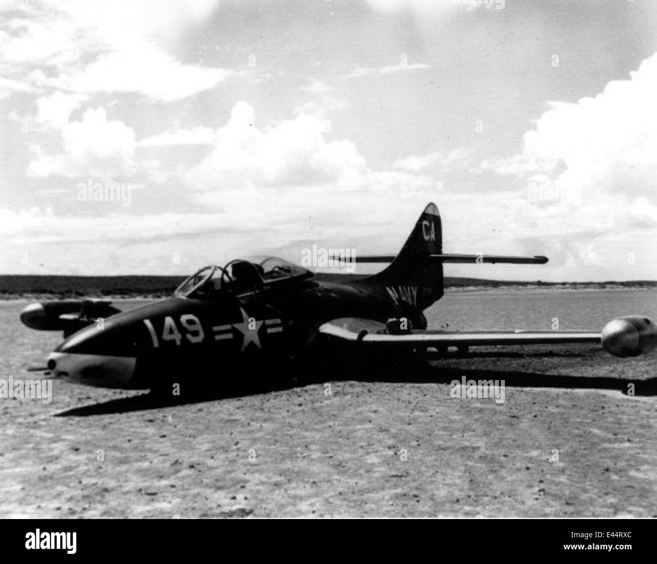 A photograph capturing the aftermath of the crash of an F9F-5 aircraft ...