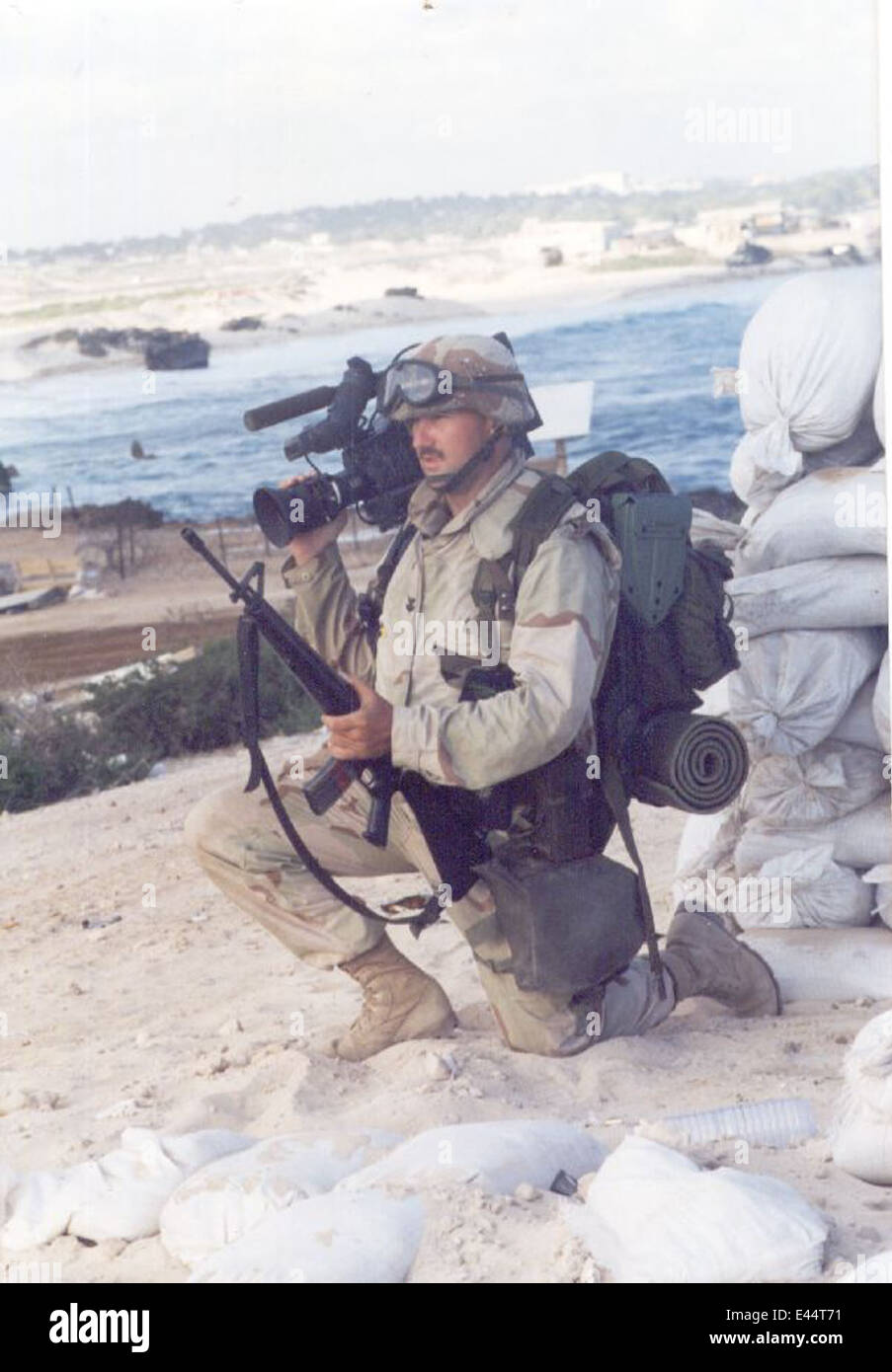 A photograph of a combat cameraman in action, documenting military ...