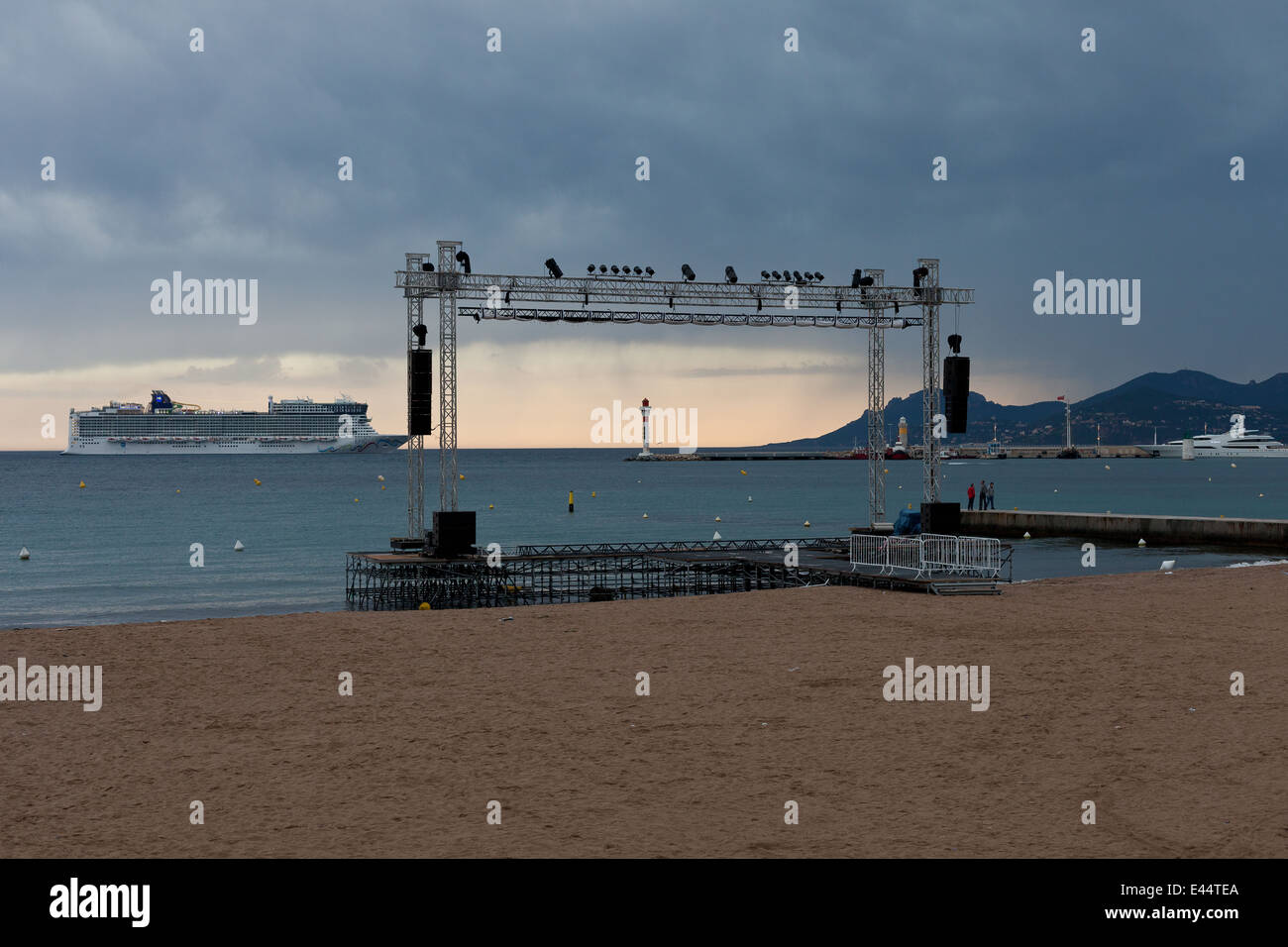Stage, lighthouse, pier, cruise ship, ocean and mountains in Cannes ...