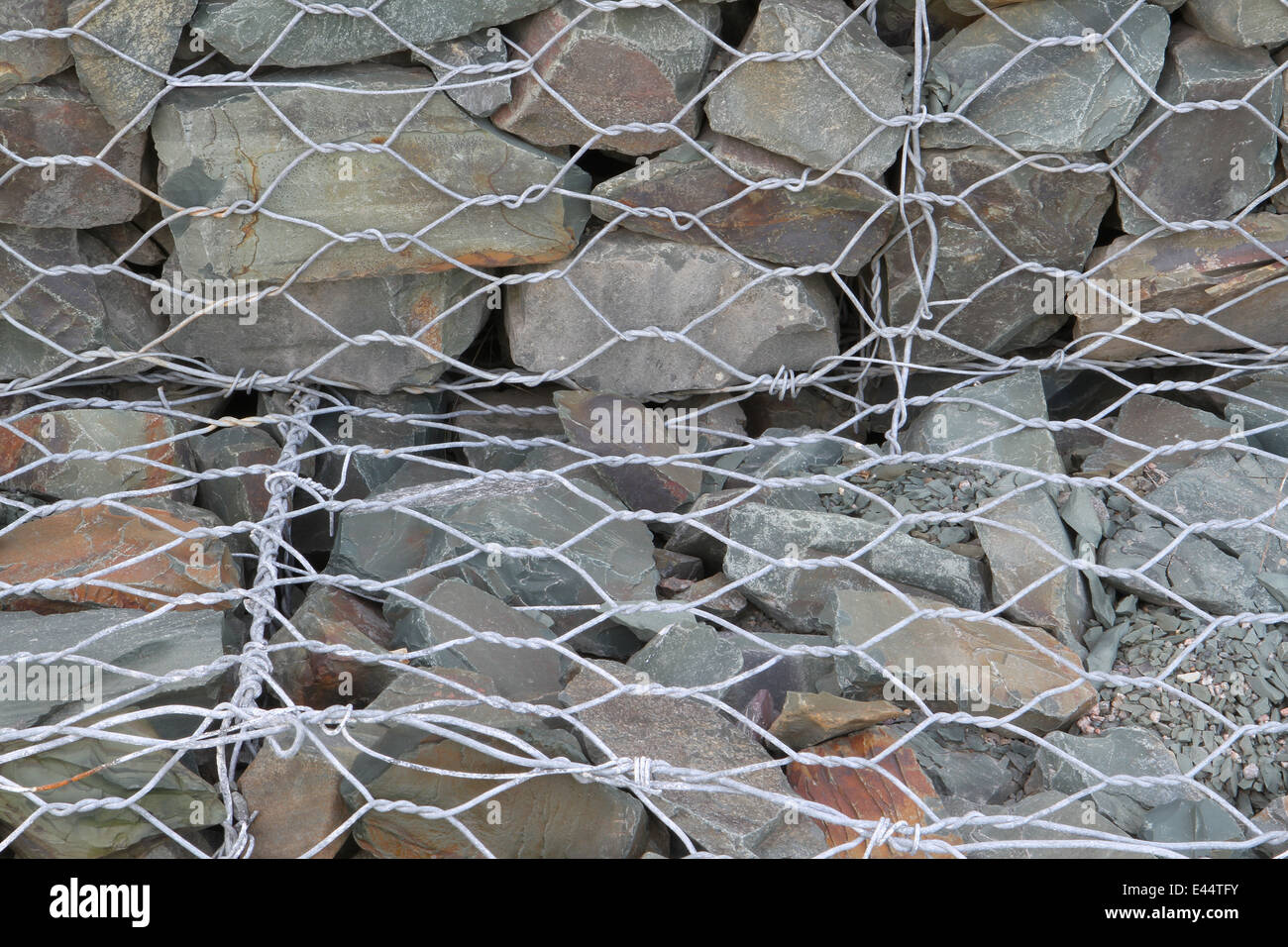 Rock fence with split rock and hexagonal like wire similar to chicken ...