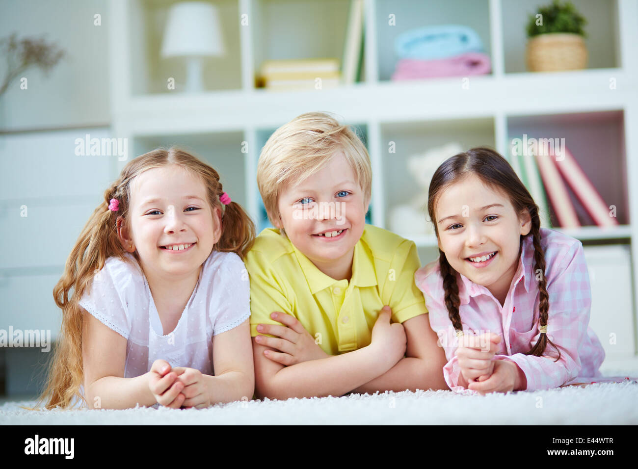 Three little friends looking at camera with smiles Stock Photo - Alamy