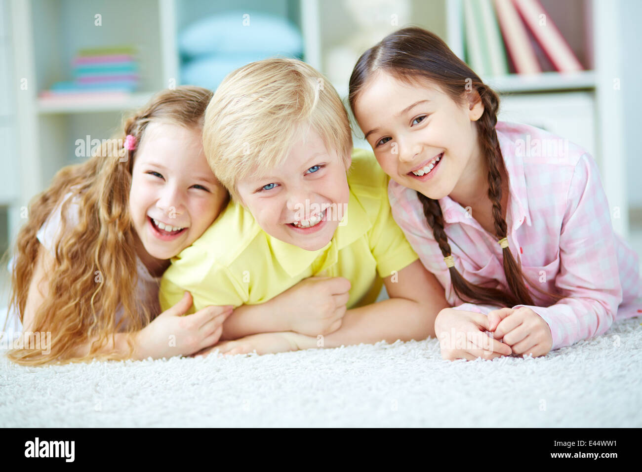 Three joyful friends looking at camera with smiles Stock Photo - Alamy