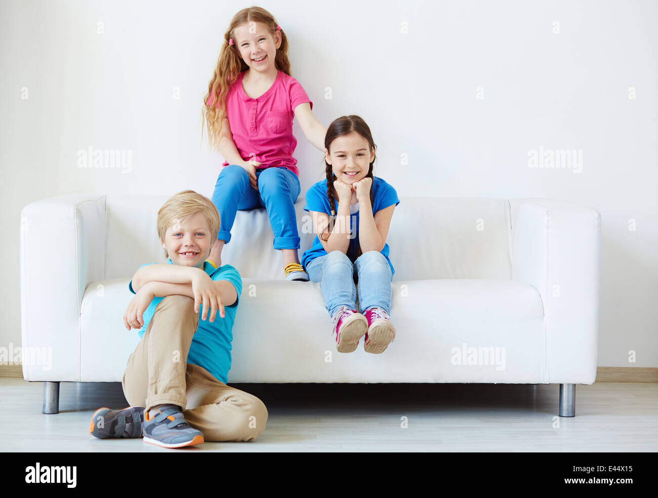 Three little friends looking at camera with smiles Stock Photo - Alamy