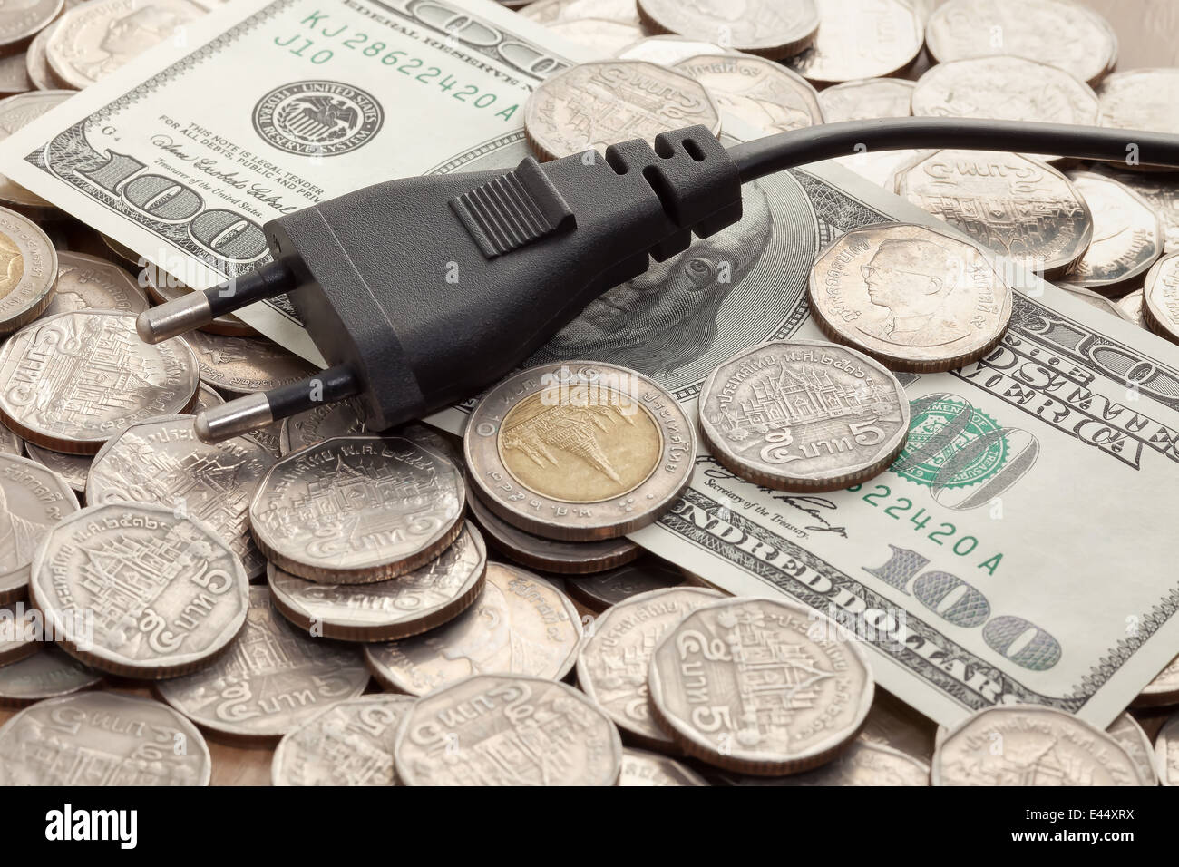 Power plug on bills and coins Stock Photo - Alamy