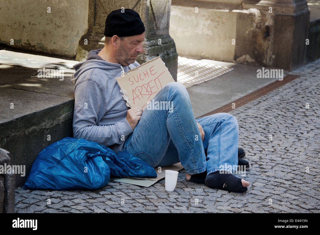 A homeless person is looking for new work. Unemployed beggars living on ...
