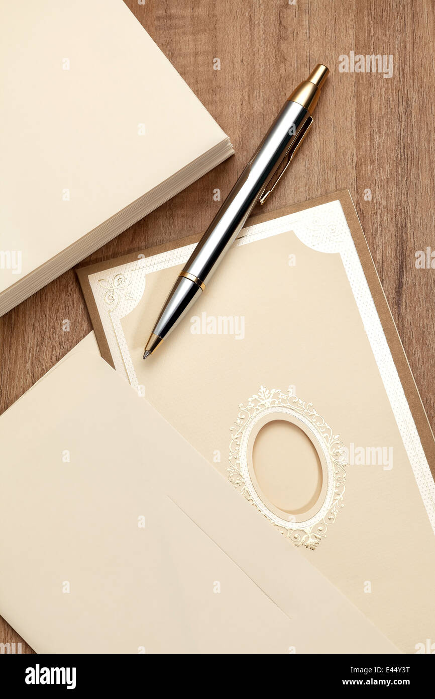 Invitation card with pen on table Stock Photo - Alamy