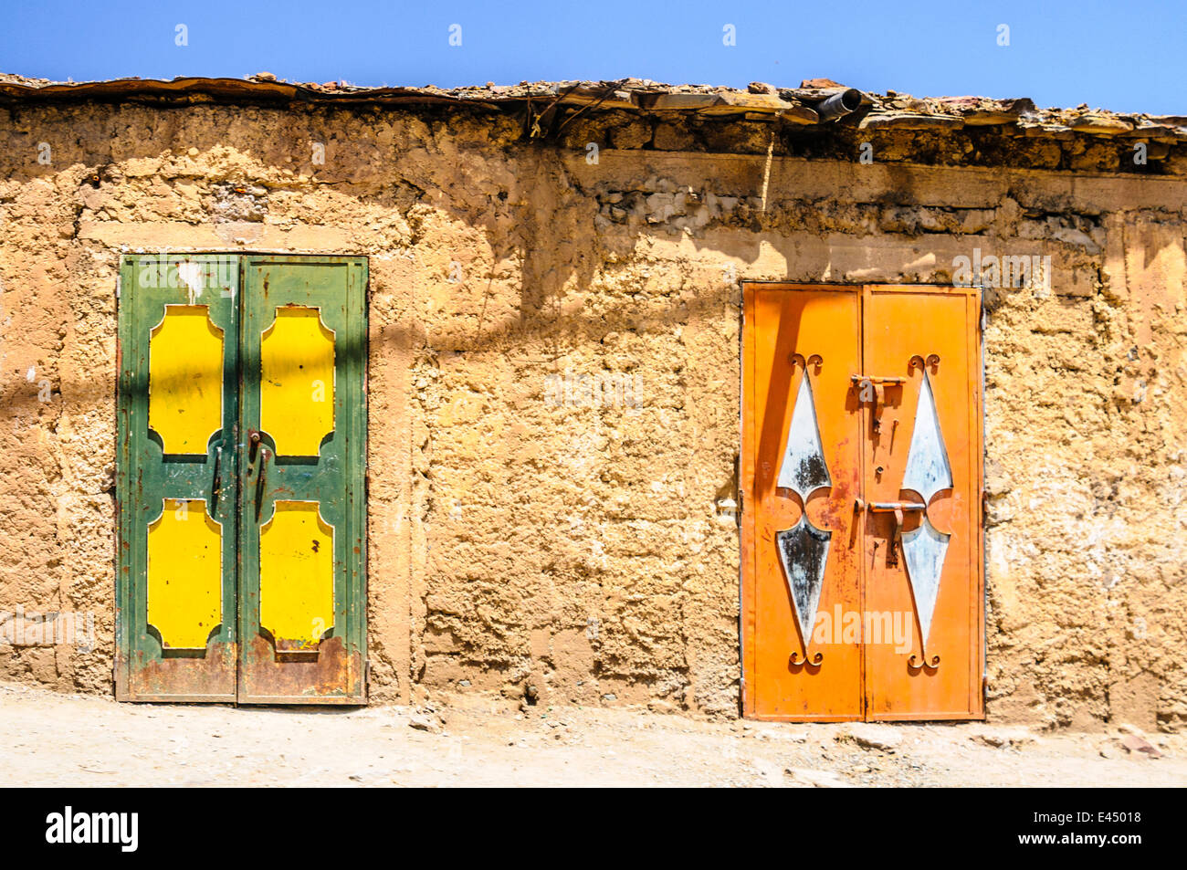 Multi-coloured ornate doors on a traditional rural Berber building in ...
