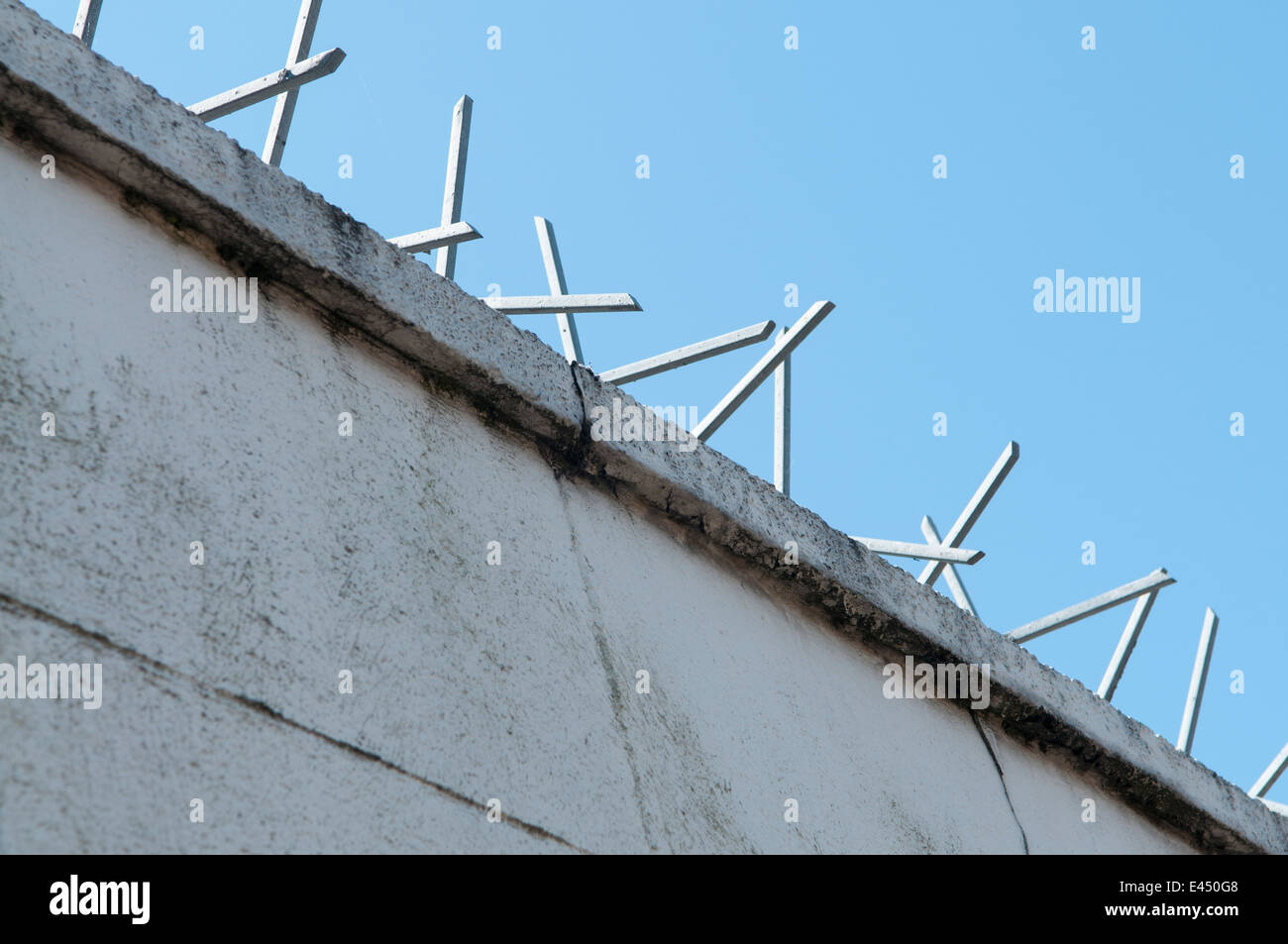 Security spikes on top of a wall Stock Photo - Alamy
