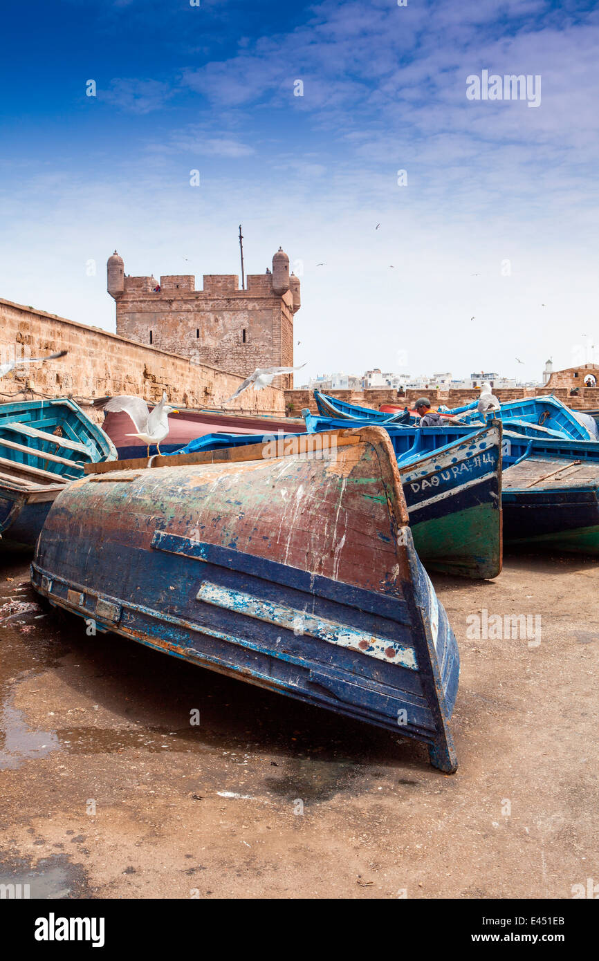 Traditional, blue painted fishing boats in the harbour below the Sqala ...