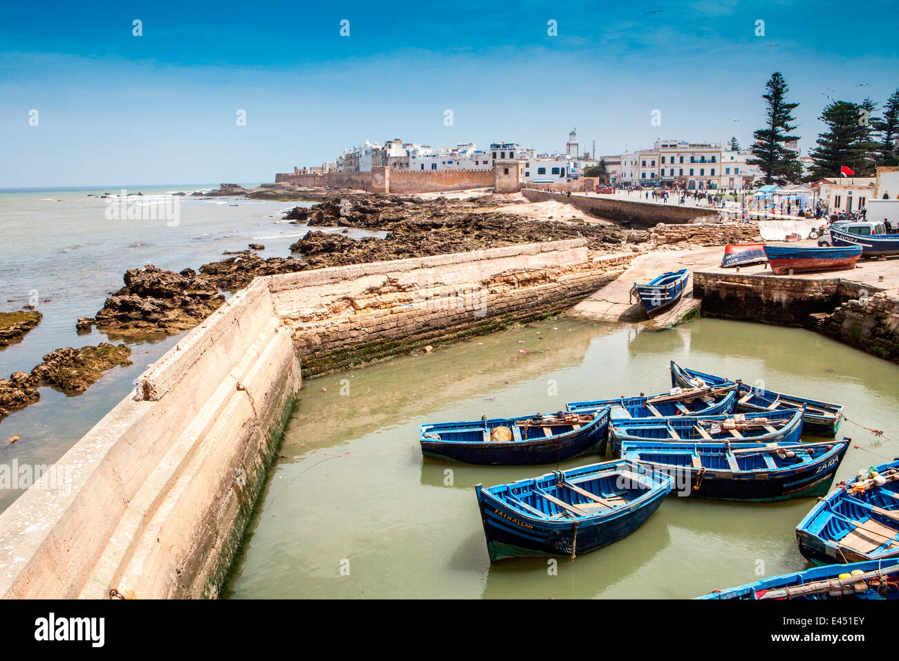 Traditional, blue painted fishing boats in the harbour below the Sqala ...