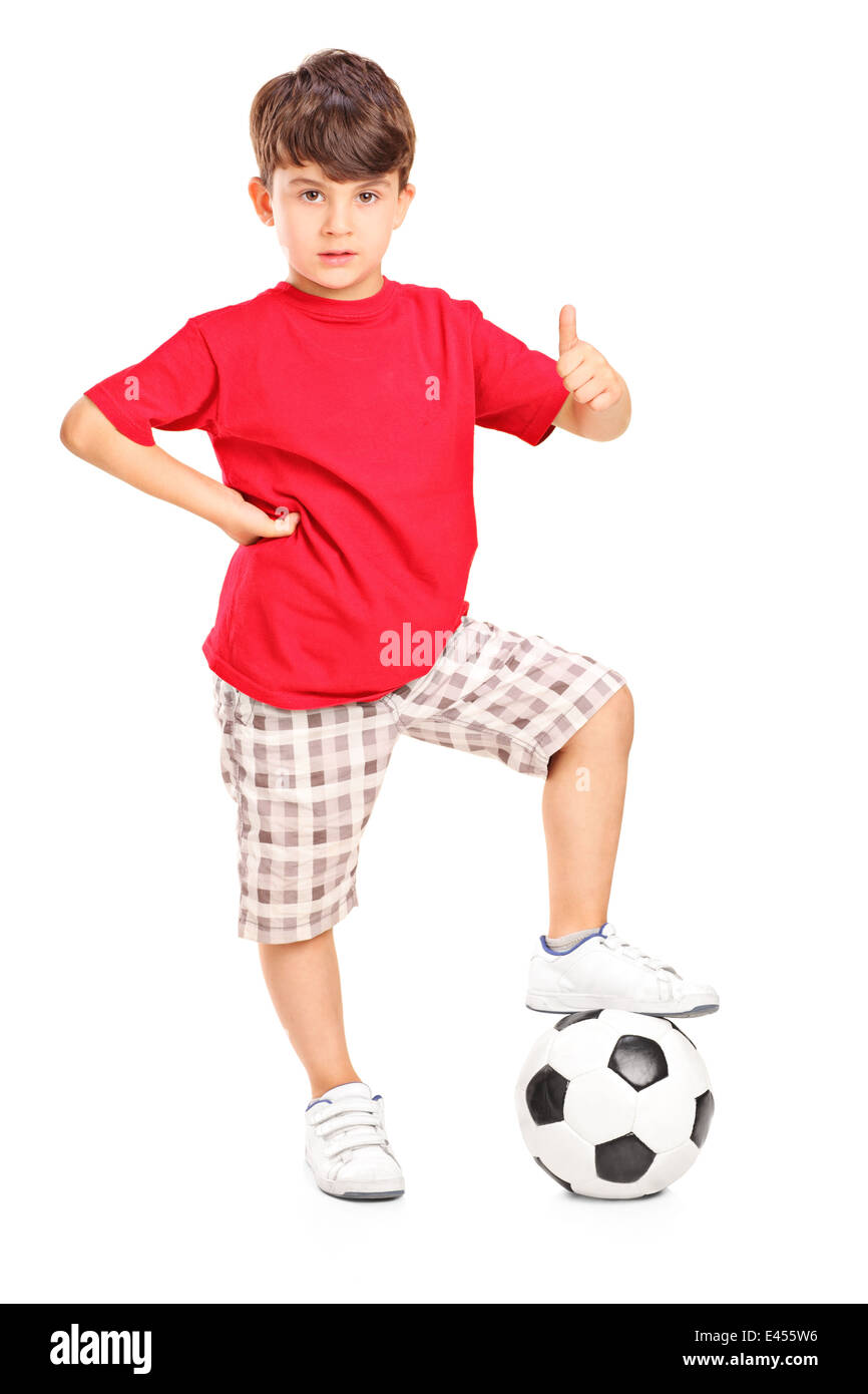 Full length portrait of a kid with a football under his foot giving a ...