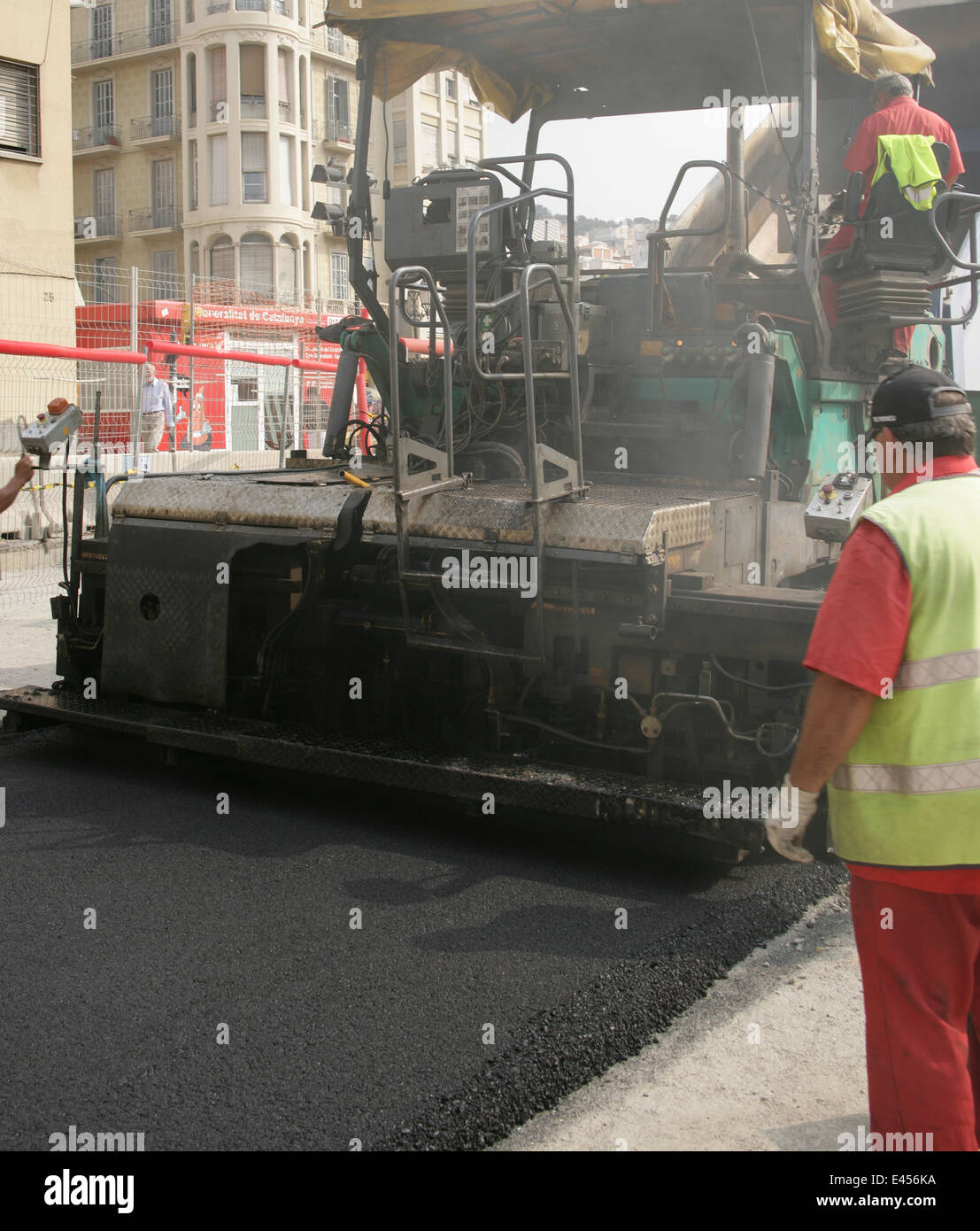 Paving work. Asphalt paving machine. New asphalt surface on the ...