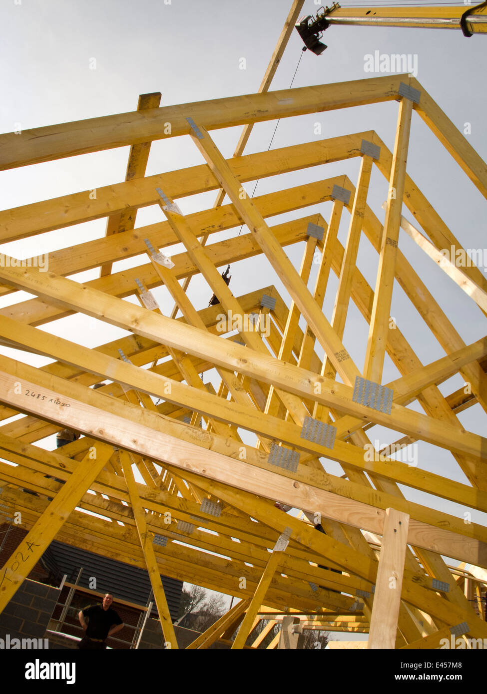 self building house, constructing roof, lifting roof trusses into ...
