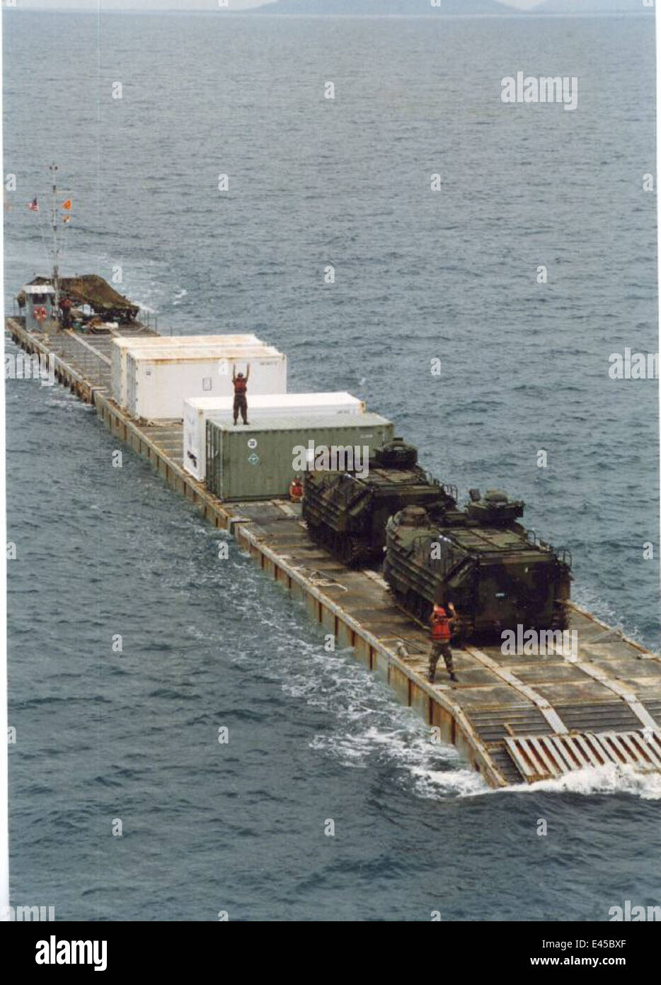 A photograph capturing a barge ferry in amphibious exercise ...