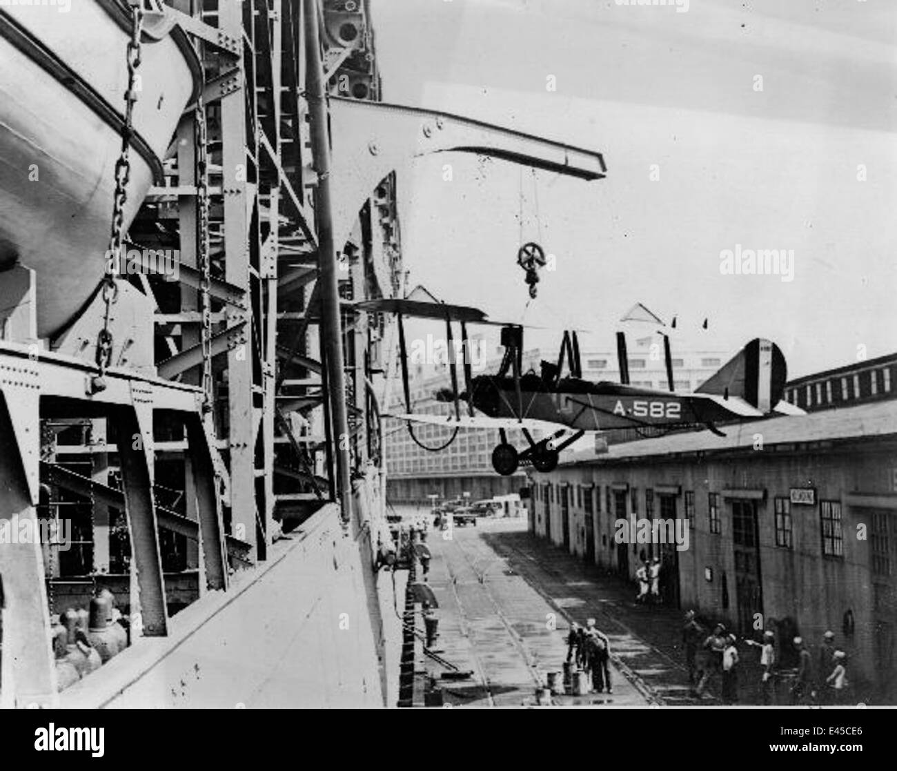 This image shows the hoisting of an Aeromarine 39B aircraft, a type of ...