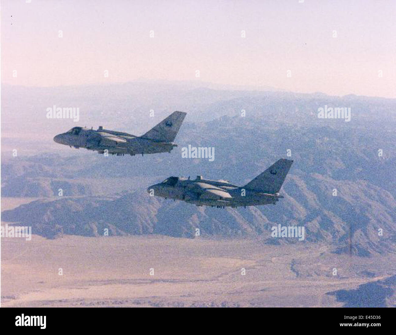 A photograph of a VQ-5 ES-3A aircraft flying over a desert landscape in ...