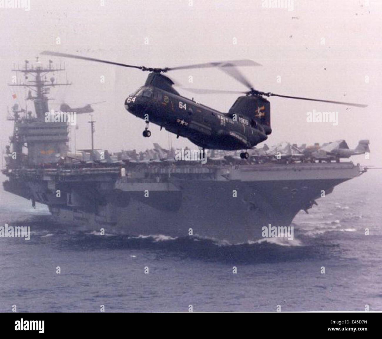 Two CH-46A Sea Knight helicopters performing a vertical replenishment ...