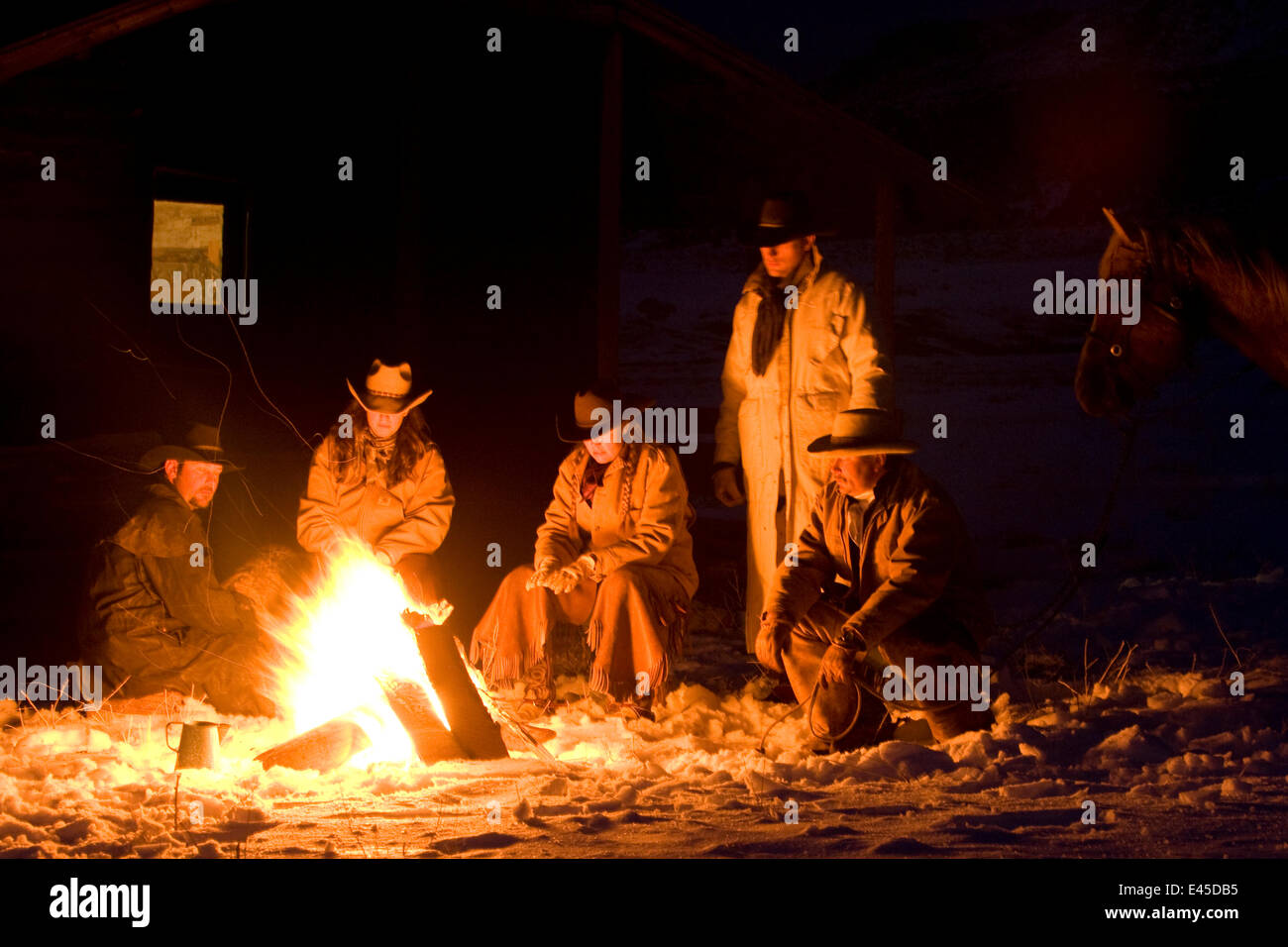 Cowboys sitting round camp fire, Flitner Ranch, Shell, Wyoming, USA ...