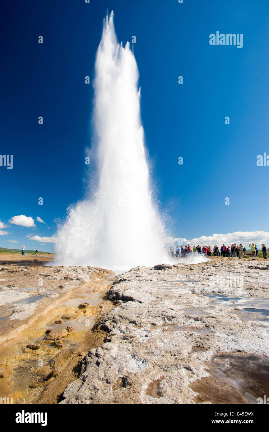 Tourists watching eruption of The Strokkur, the biggest geyser active ...