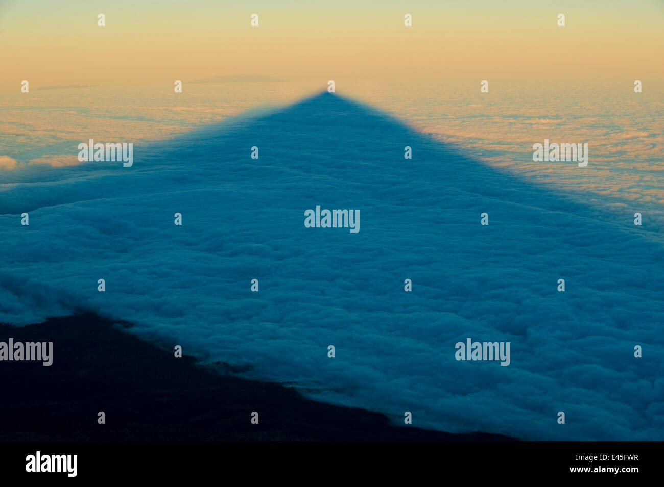 Shadow of the Teide volcano in sea of clouds at sunset, Teide National ...