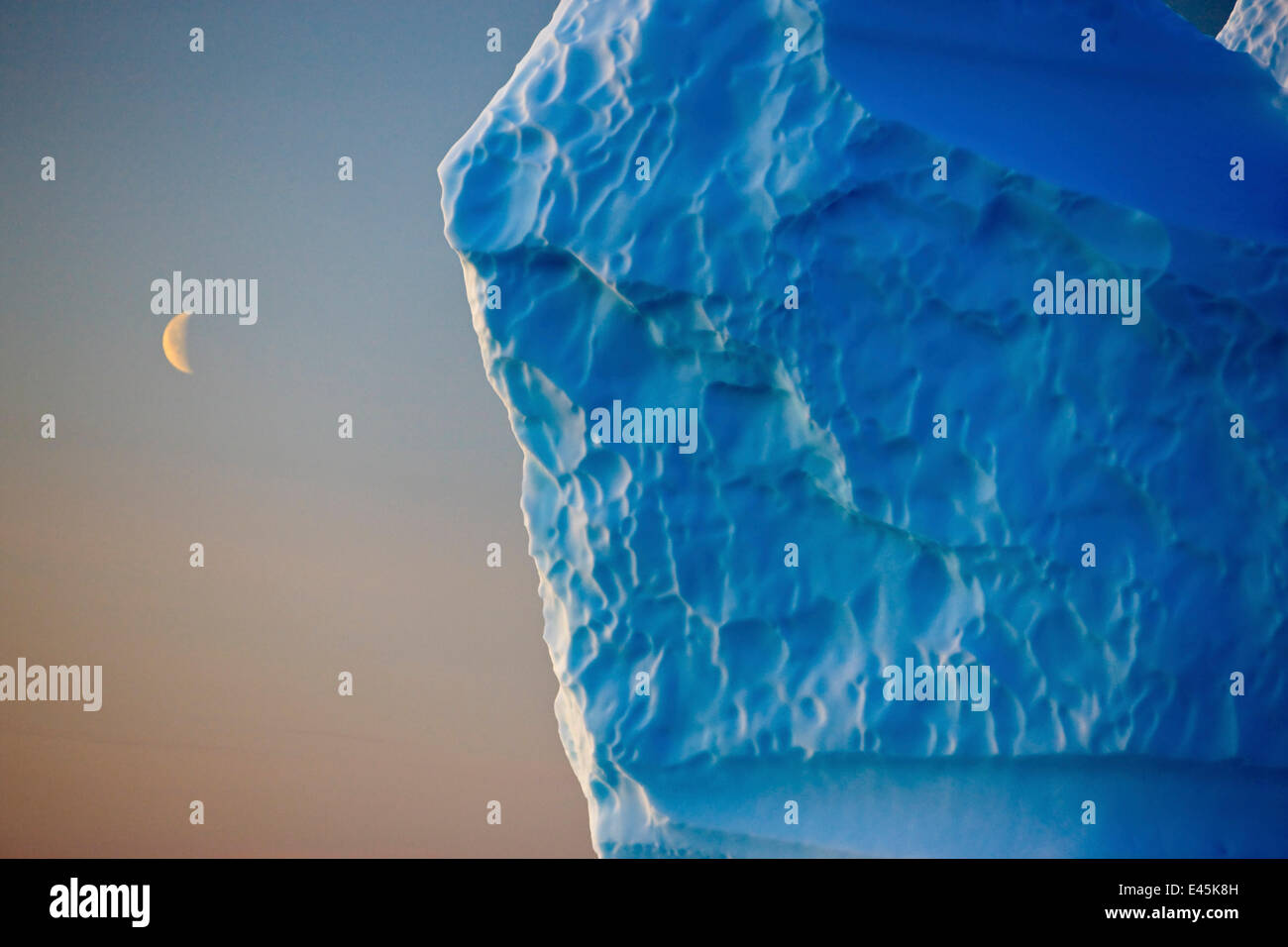 Edge of iceberg with the moon in the sky, Greenland, August 2009 Stock ...