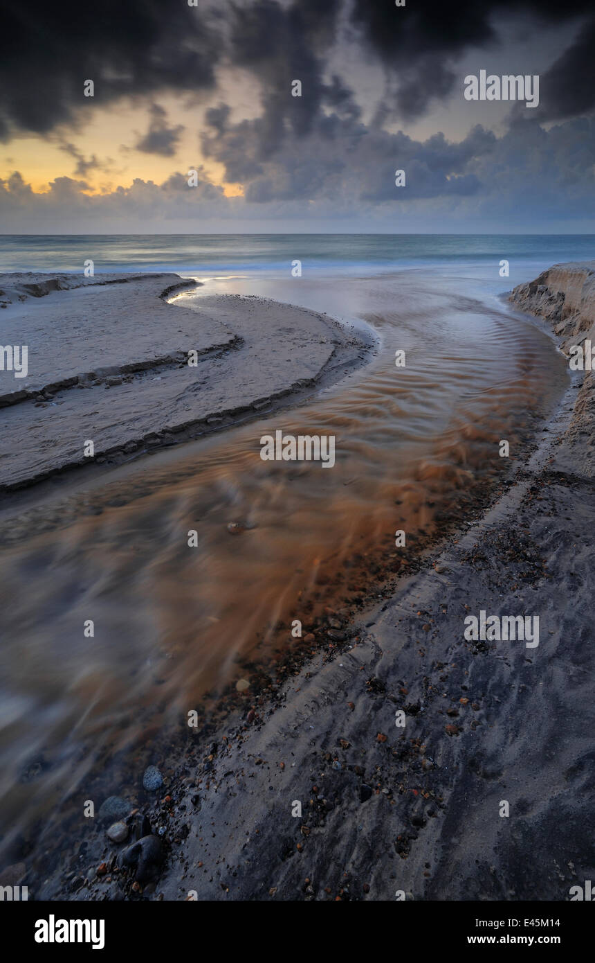 River flowing into the North Sea at dusk, Klitmøller, Thy National Park ...