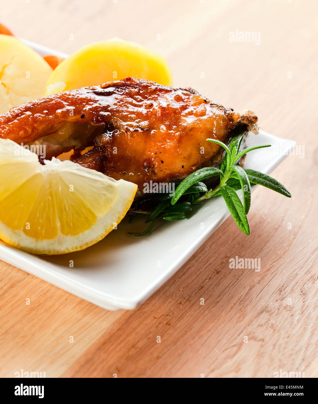 fried fish with lemon and boiled potato Stock Photo - Alamy