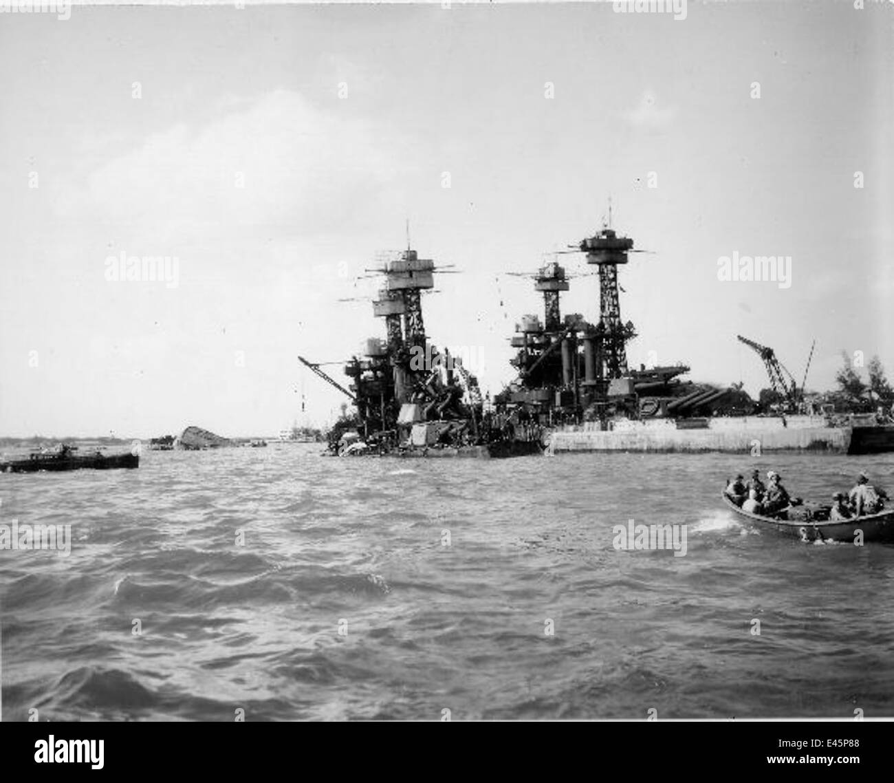 This photograph shows a damaged battleship at Pearl Harbor in 1941 ...