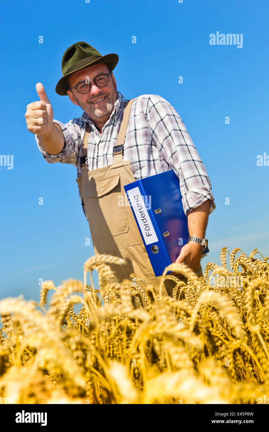 A farmer with support folder on crop field, subsidies in agriculture ...