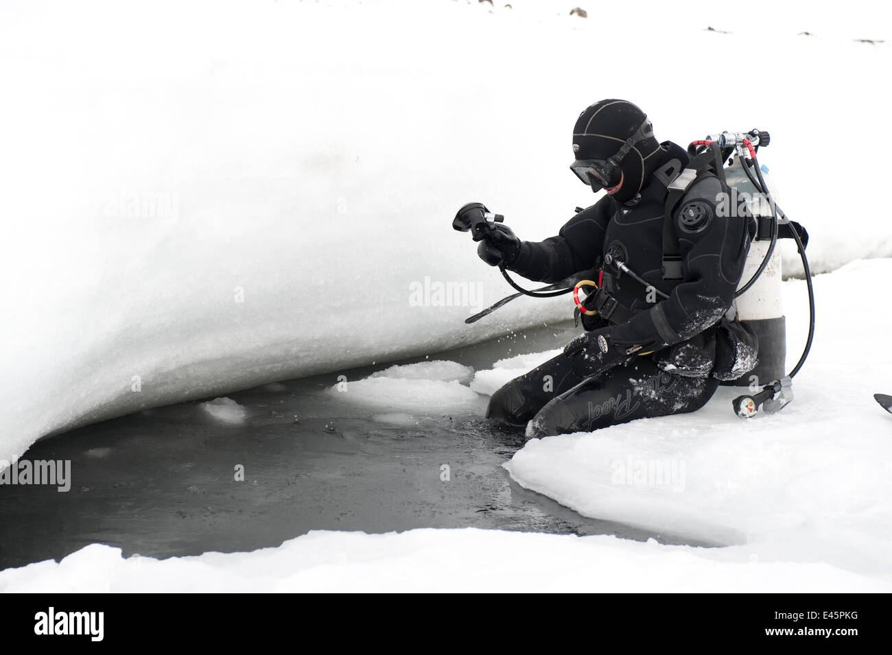 Doug Allan, BBC cameraman, preparing to enter ice-hole for underwater ...