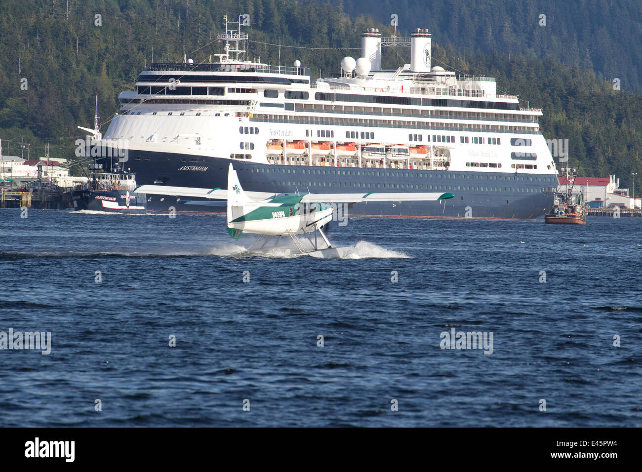 Sightseeing seaplane landing in front of docked cruise ship, Ketchikan ...