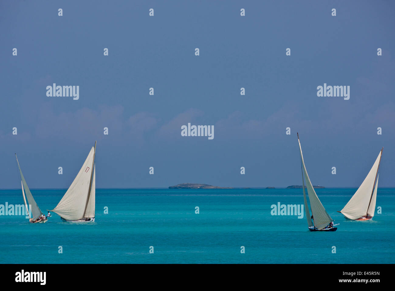 Four boats sailing on turquoise seas during the Bahamian Sloop regatta ...