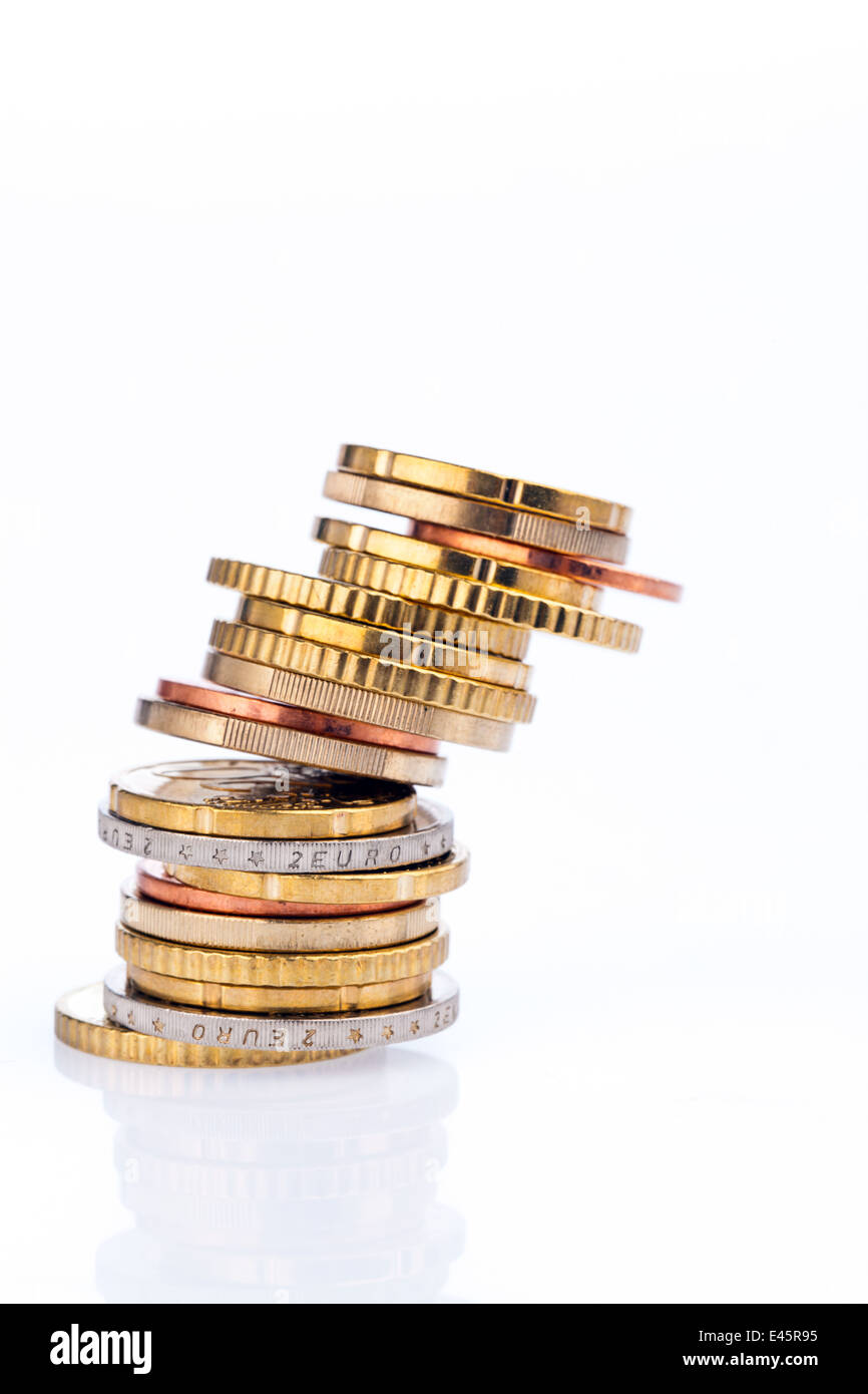 A toppling stack of coins of euro cents. Isolated on white background ...