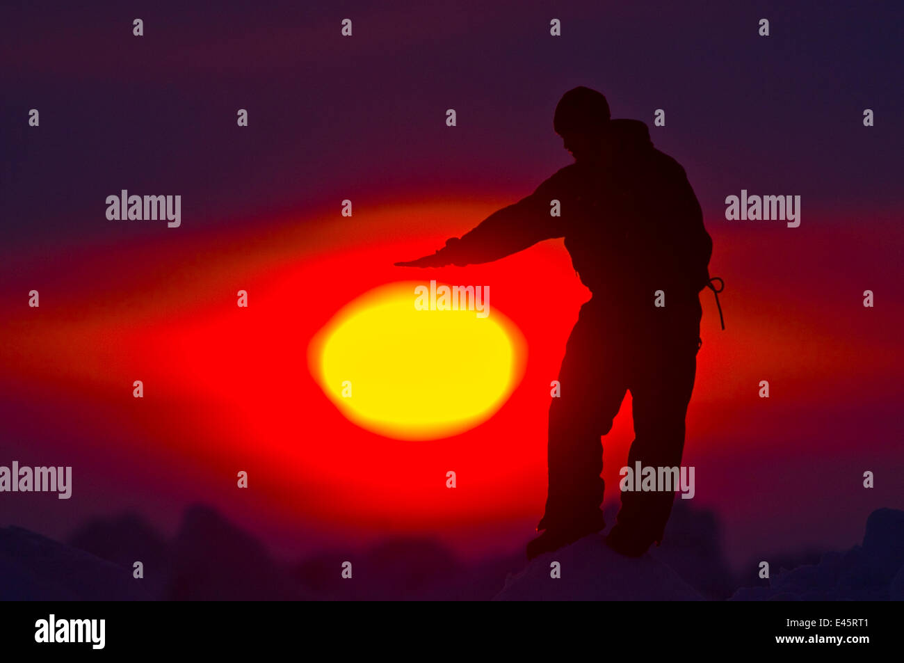 Inupiaq / Inuit man hold his hand under the midnight sun in the Chukchi ...
