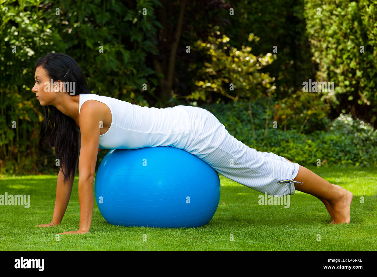 A young woman exercises on an exercise ball Stock Photo - Alamy