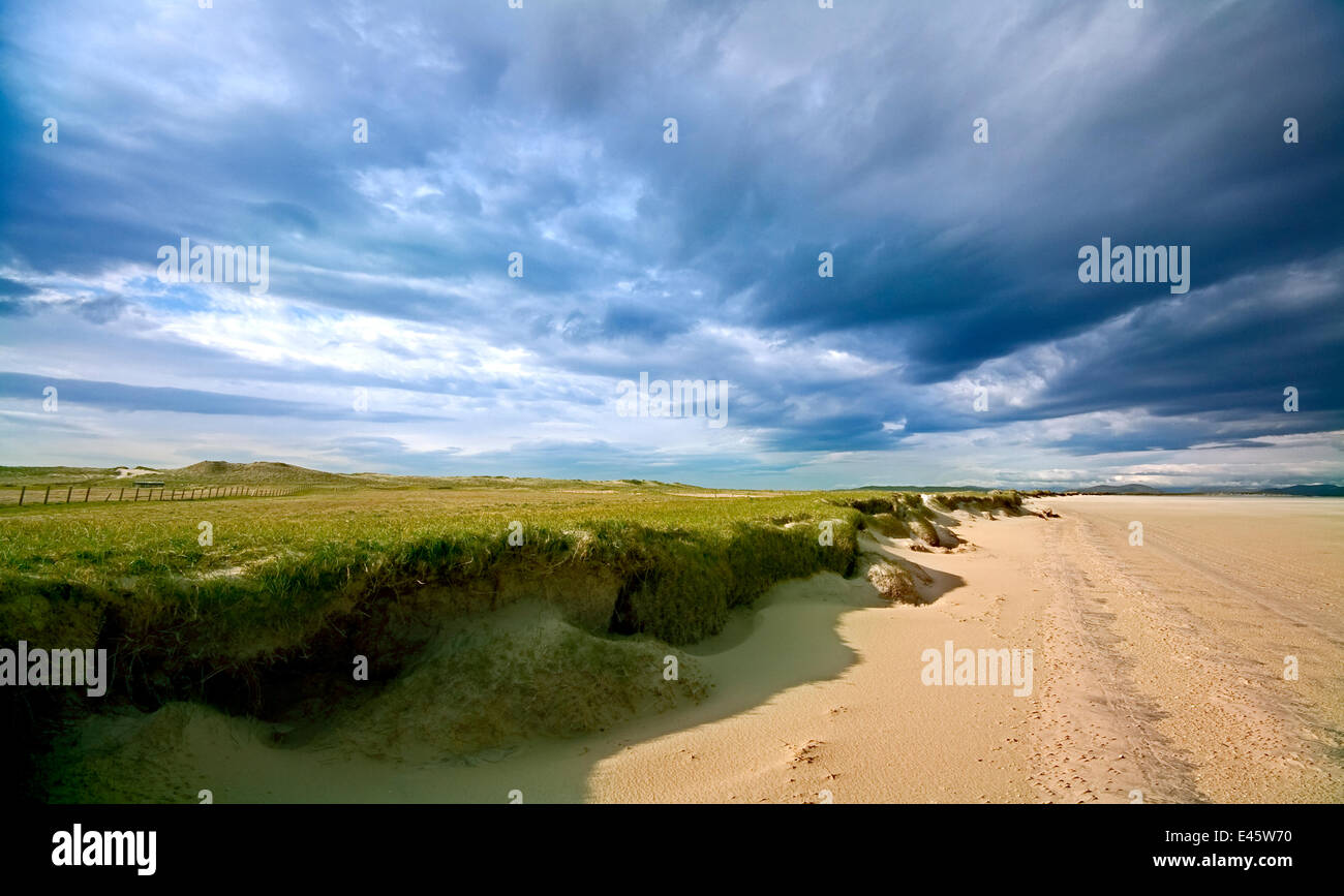 View of beach, with approaching storm clouds on North Uist, Western ...